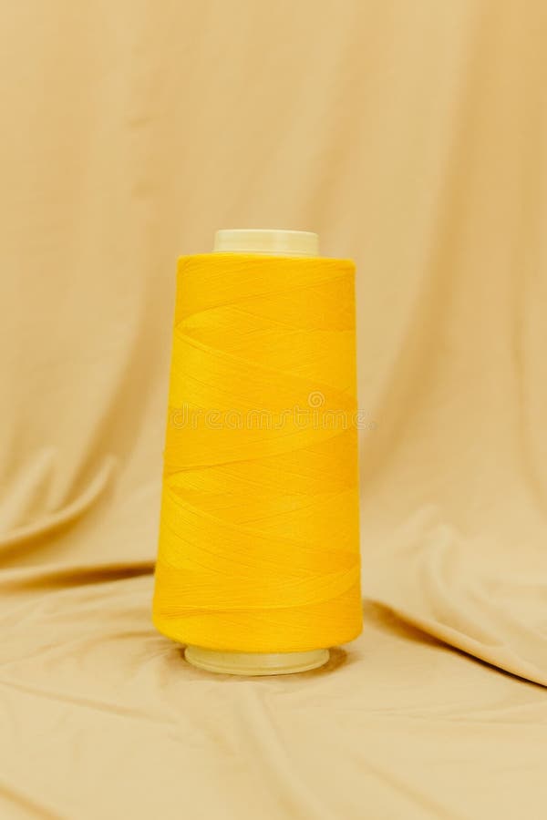 Vertical Close-up Photograph of a Yellow Spool of Thread Stock Photo ...