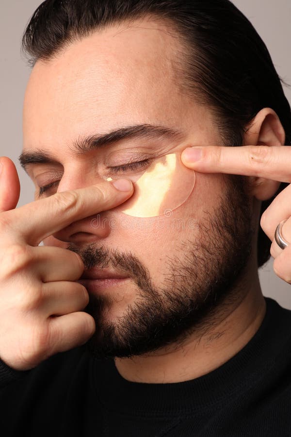 Vertical Close-up Portrait of Man Wearing Eye Patches Isolated on Light ... Vertical Close-up Portrait of Man Wearing Eye Patches Isolated on Light ...