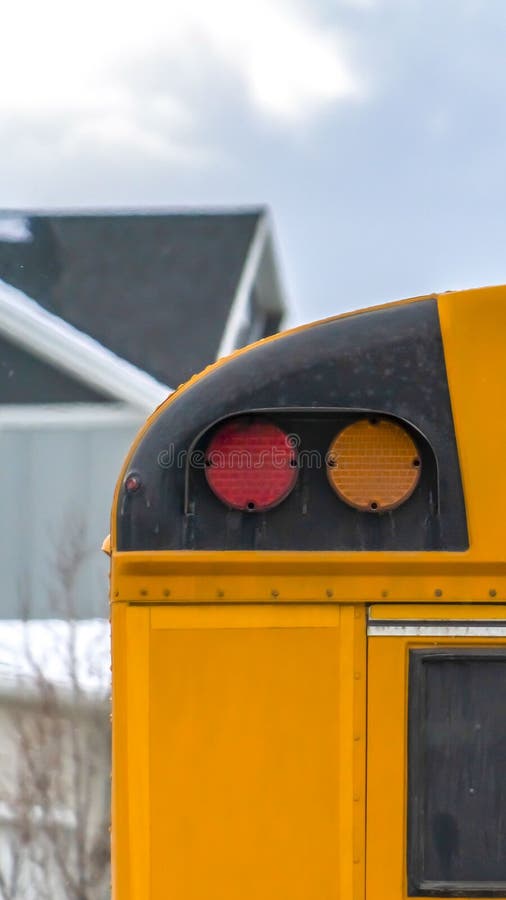 Vertical Close Up of the Rear of a School Bus with a Window and Several ...