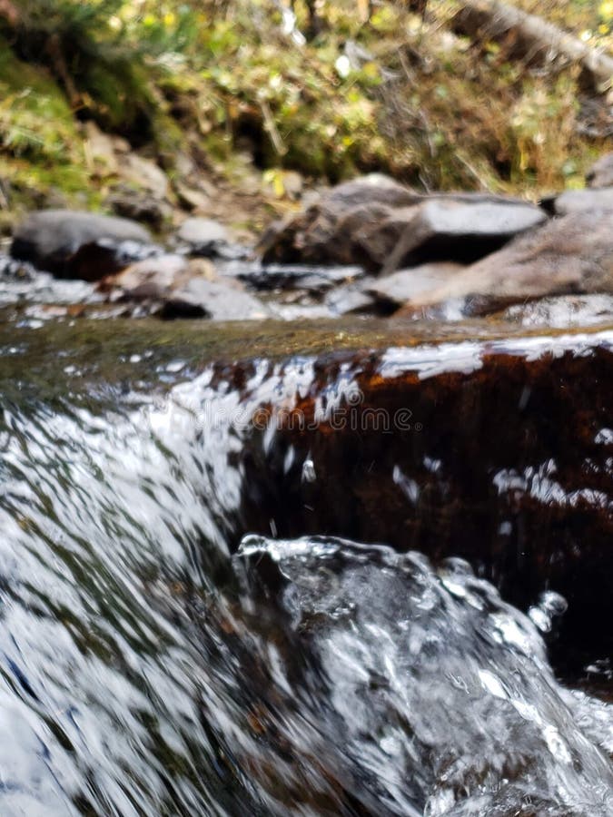Vertical Close-up Shot of a River Over Stones Stock Photo - Image of ...