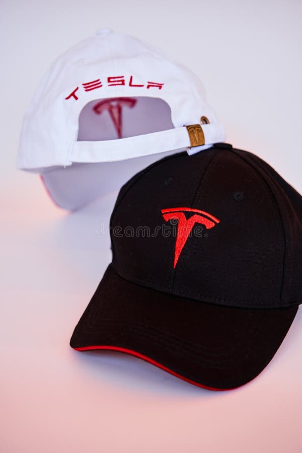 Vertical Close-up of Two Black and White Caps with Tesla Logotype in ...