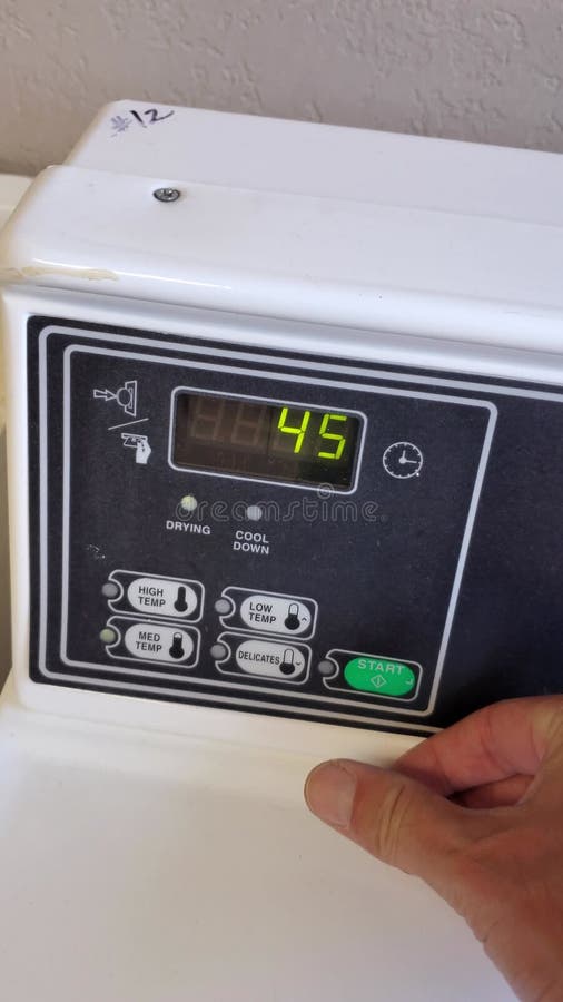 Vertical Close-up View of a Finger Pushing a Laundry Start Button Stock ...
