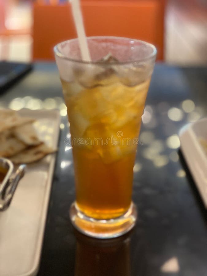 Vertical Close-up View of a Glass of Iced Tea on a Black Surface Stock ...