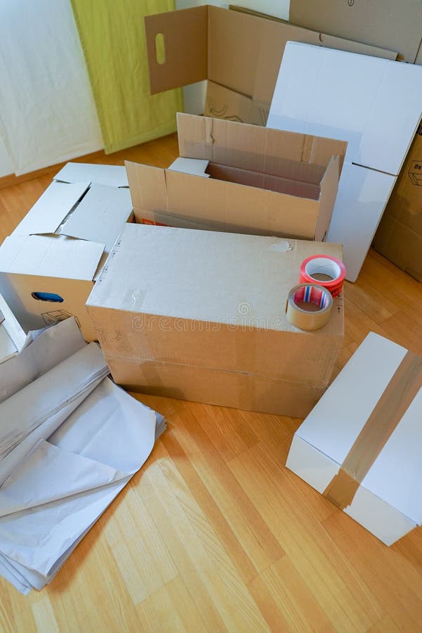 Vertical Close Up View of Moving Boxes and Materials on a Wooden ...