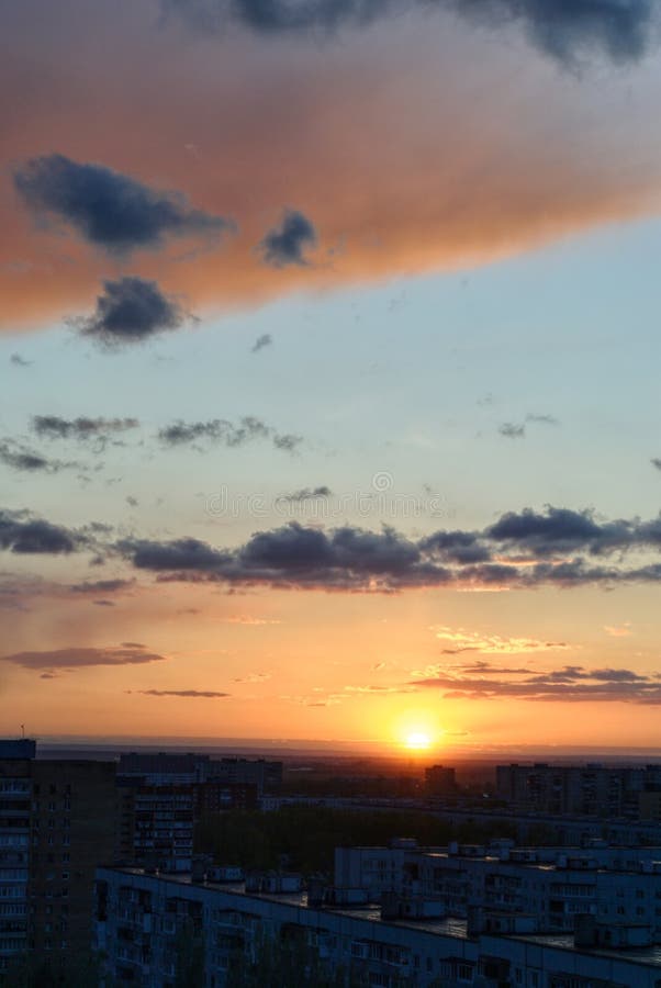 Vertical Close-up View of the Sunset Sky and Clouds Over City Blocks ...