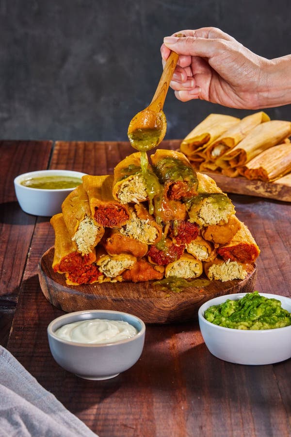 Vertical Closeup of a Chef Pouring Sauce on a Burrito Stack Stock Image ...