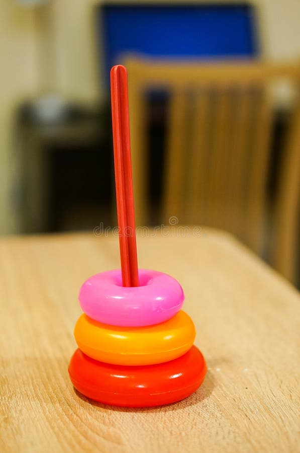 Vertical Closeup of a Colorful Stacking Tower Toy on the Table Under ...