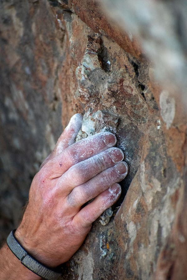 Vertical Closeup of a Dusty Hand Holding from a Rock Covered with ...