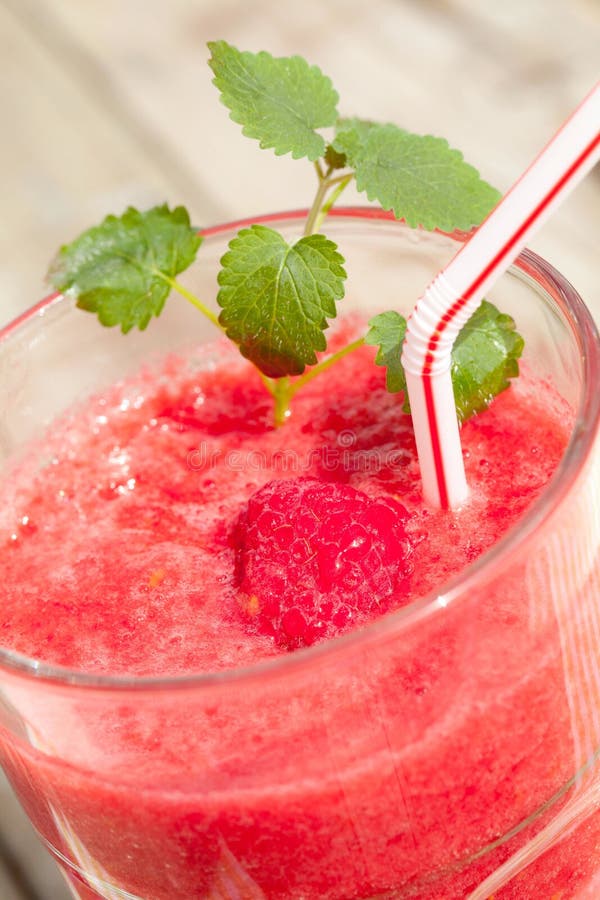 Vertical Closeup of a Glass of Raspberry Smoothie, with a Plastic Straw ...