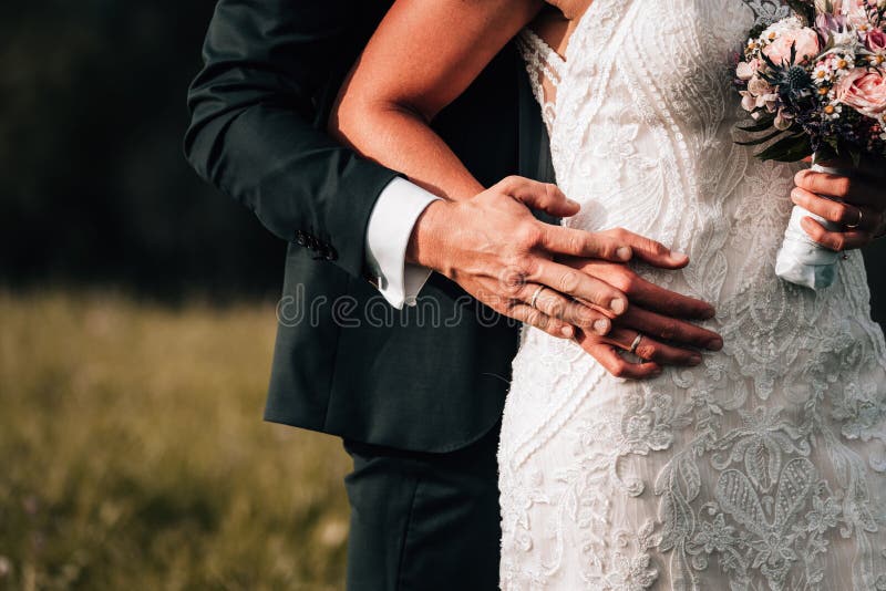 Vertical Closeup of a Groom Hugging Bride from Back Stock Image - Image ...