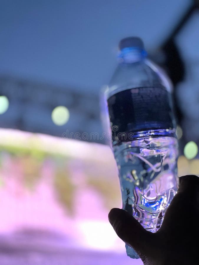 Vertical Closeup of a Hand Holding a Bottle of Water. Stock Image ...