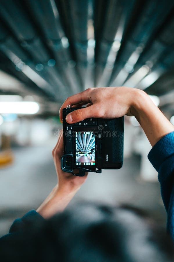 Vertical Closeup of Hands Holding a Camera and Taking Picture Blurred ...