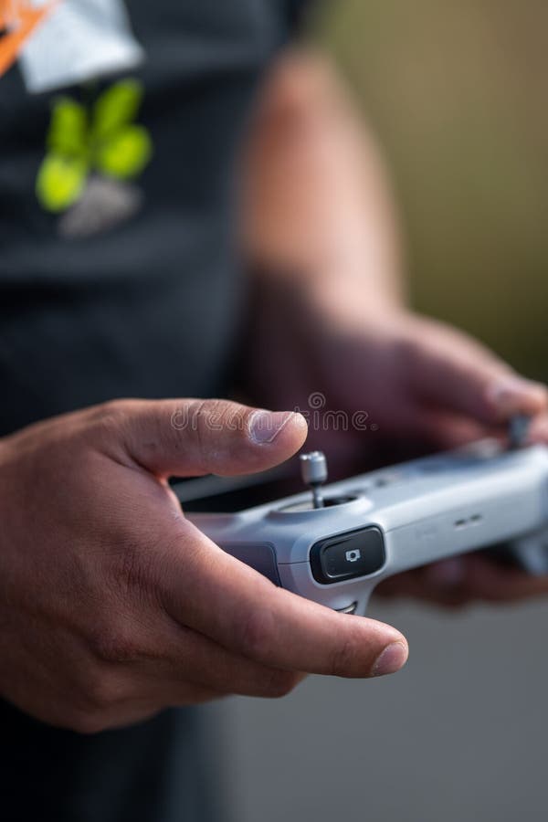 Vertical Closeup of the Hands of a Person with Controller Stock Photo ...