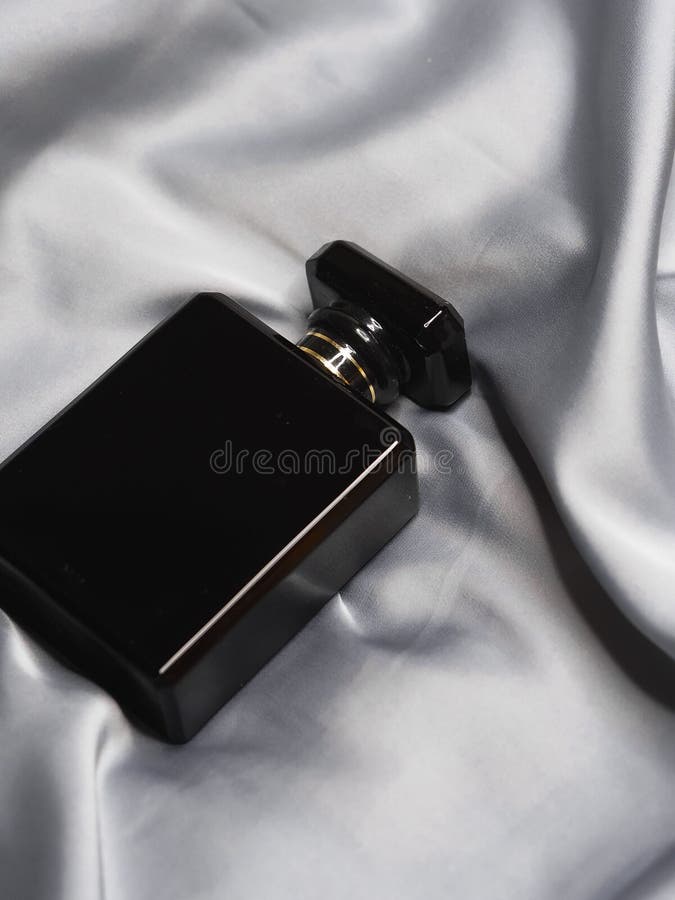 Vertical Closeup High-angle Shot of a Black Perfume Bottle on a Grey ...
