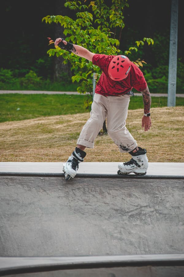Vertical Closeup of an Inline Skater in a Skating Rink Practicing Moves ...