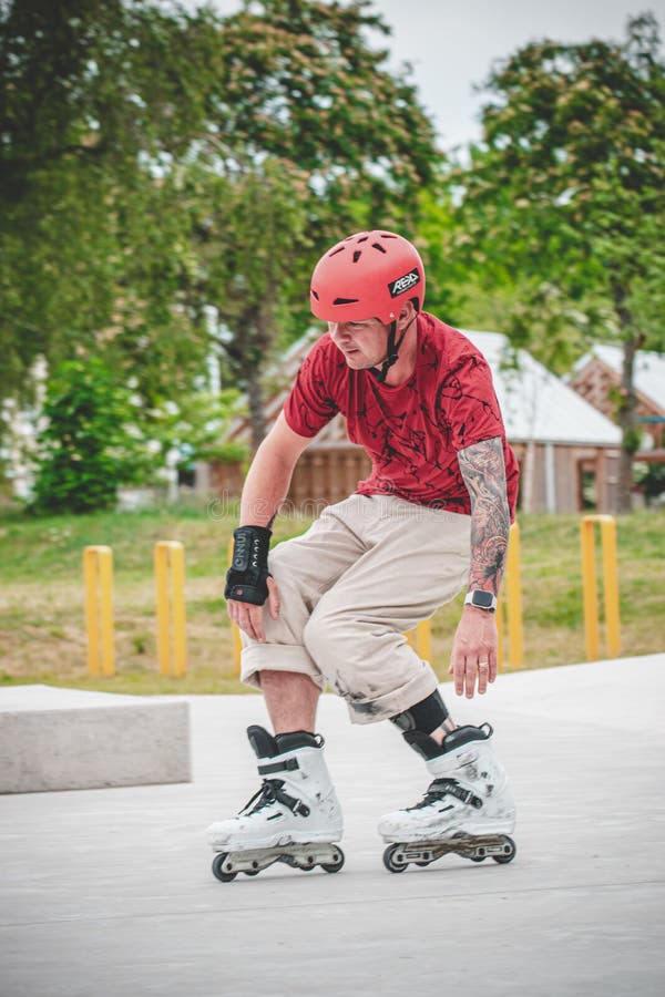 Vertical Closeup of an Inline Skater in a Skating Rink Practicing Moves ...