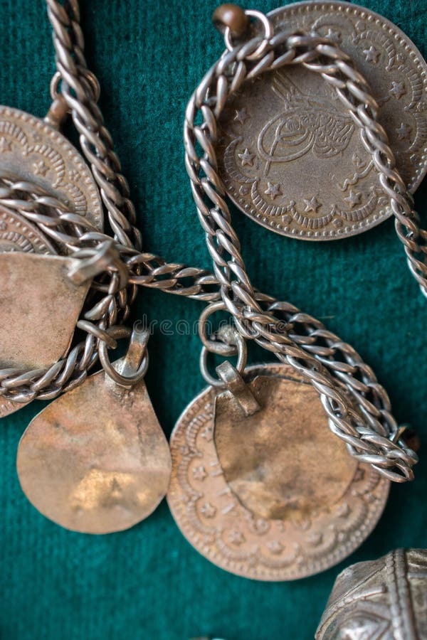 Vertical Closeup of Old Coins Connected To Each Other Via a Chain on a ...
