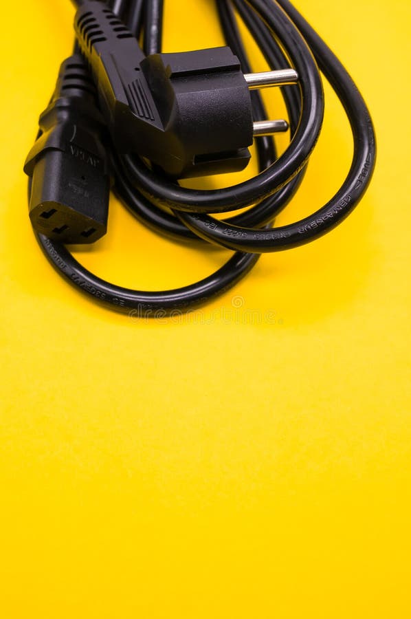 Vertical Closeup of a Power Cable on a Yellow Background Stock Photo ...