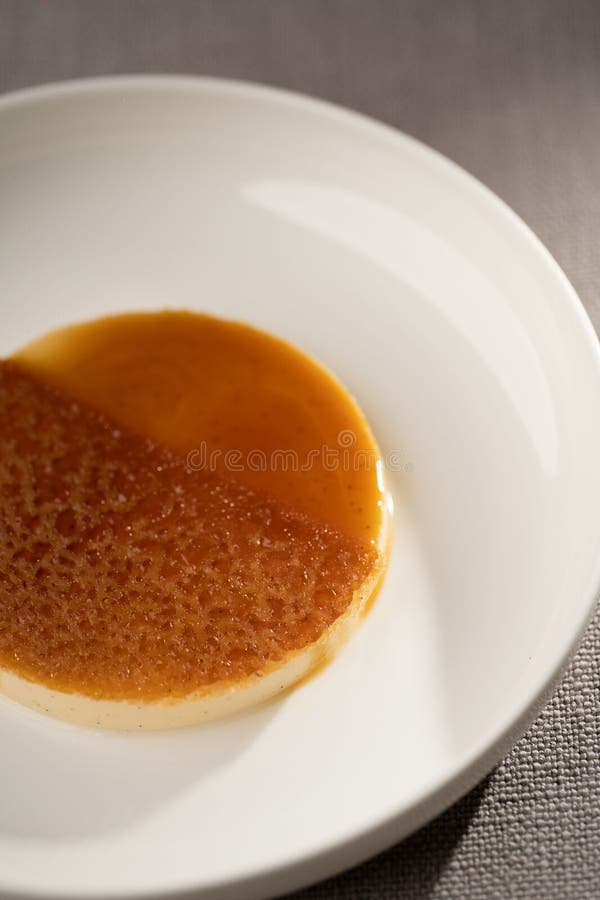 Vertical Closeup of a Pudding with Caramel Sauce on a Plate Stock Image ...