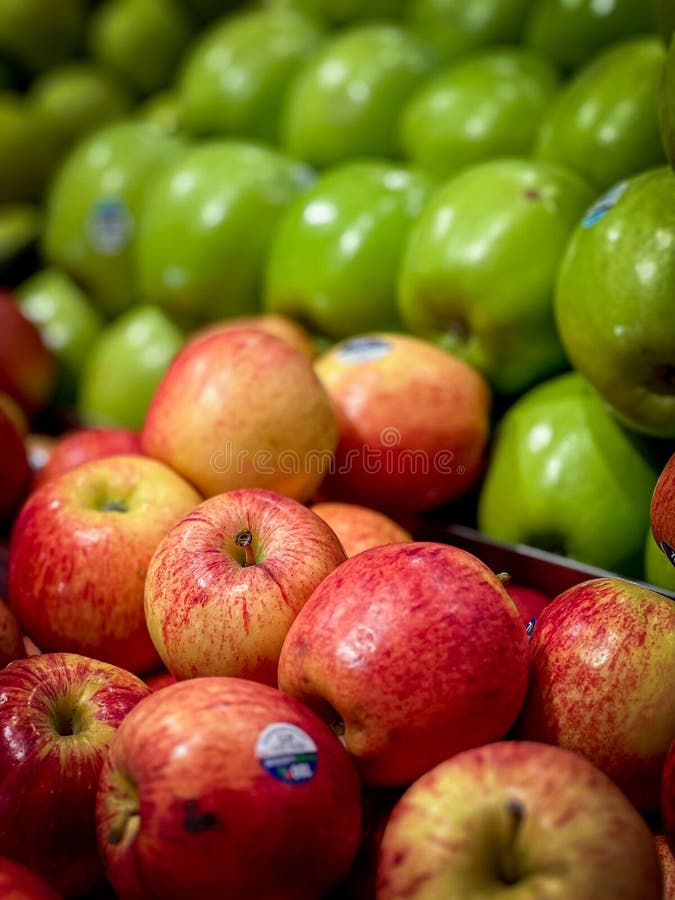 Vertical Closeup of Ripe Red and Green Apples on a Stack in a Market ...