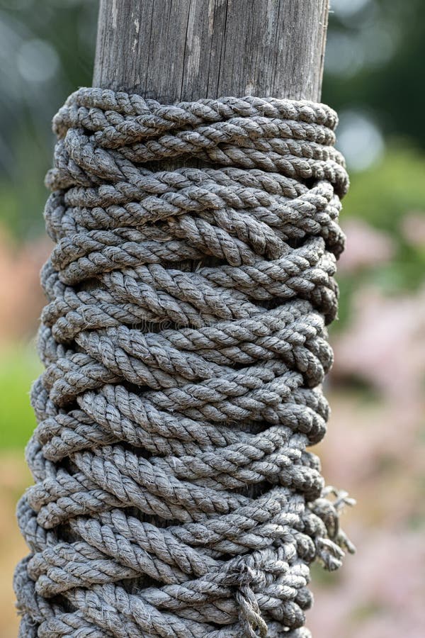 Vertical Closeup of Ropes Tied Around a Wooden Pole Stock Image - Image ...