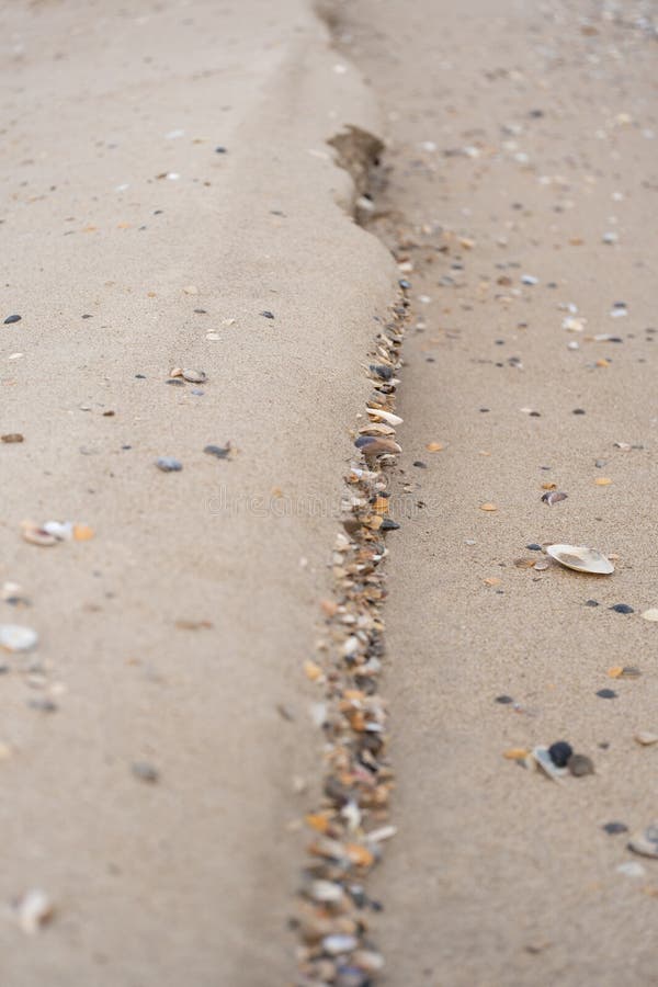 A Vertical Closeup of a Sandy Beach Surface Featuring a Natural Ridge ...
