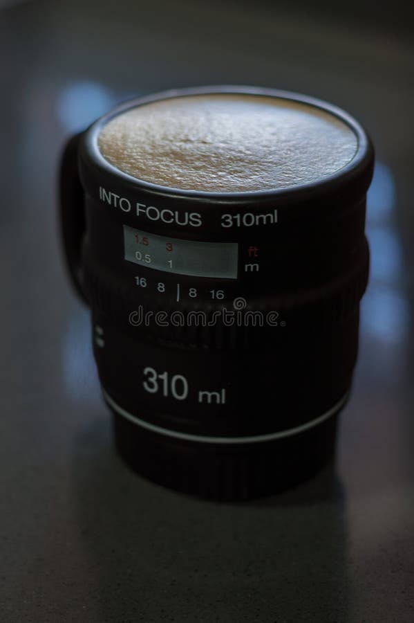 Vertical Closeup Shot of a Camera-shaped Cup Filled with Cappuccino ...