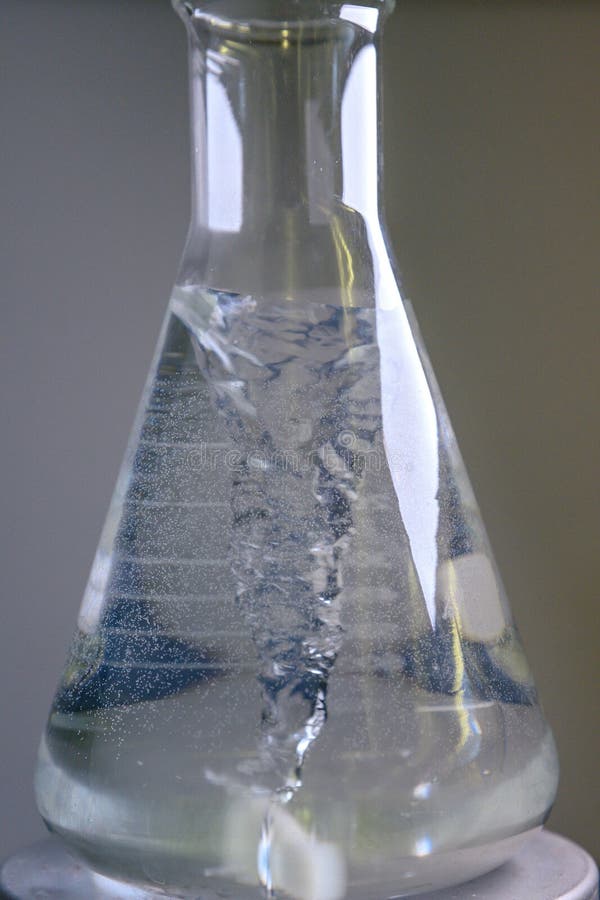 Vertical Closeup Shot of a Laboratory Glass Flask Filled with a Liquid ...