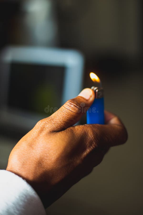 Vertical Closeup Shot of a Man S Hand Holding a Blue Lighter with a ...