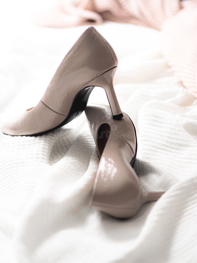 Vertical Closeup Shot of a Pair of Beige High Heels on a White Cloth ...