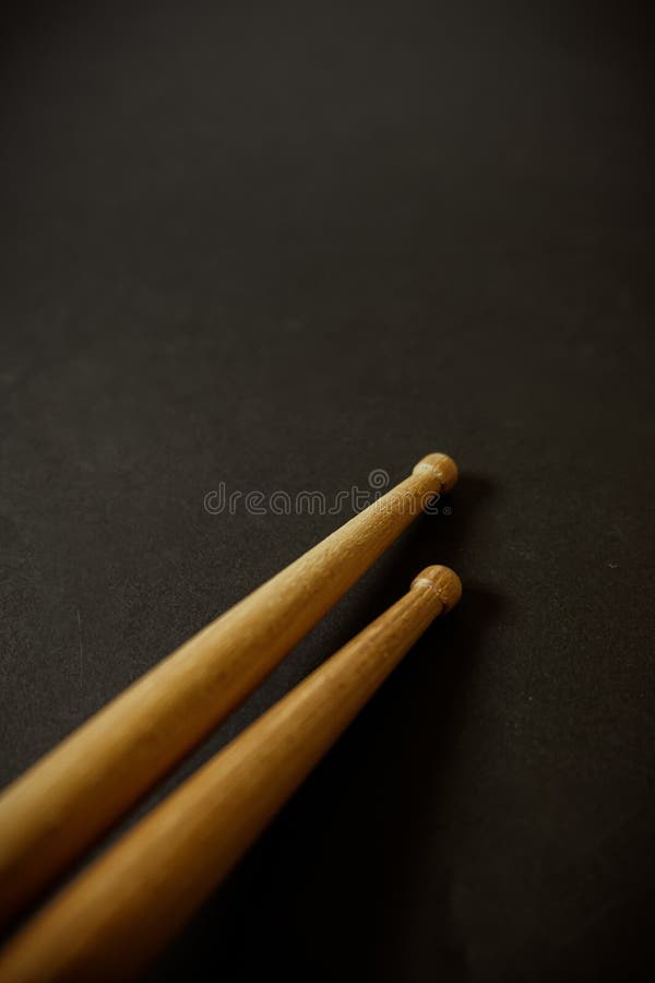 Vertical Closeup Shot of a Pair of Drum Sticks on a Black Surface Stock ... Vertical Closeup Shot of a Pair of Drum Sticks on a Black Surface Stock ...