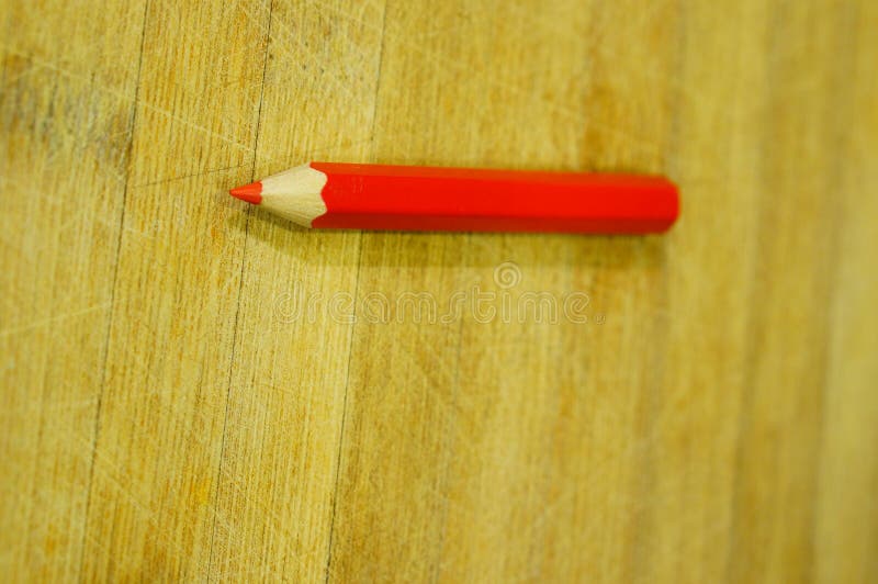 Vertical Closeup Shot of a Red Drawing Pencil on a Wooden Surface Stock ...