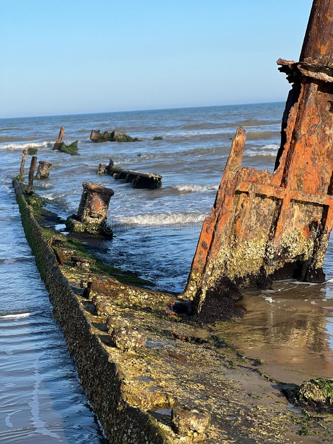 Vertical Closeup Shot Of A Rusty And Old Shipwreck On The Surface Of A
