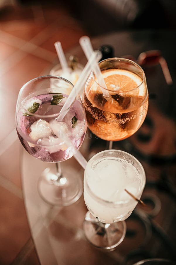 Vertical Closeup Shot of Three Glasses of Drinks Placed on a Glass ...