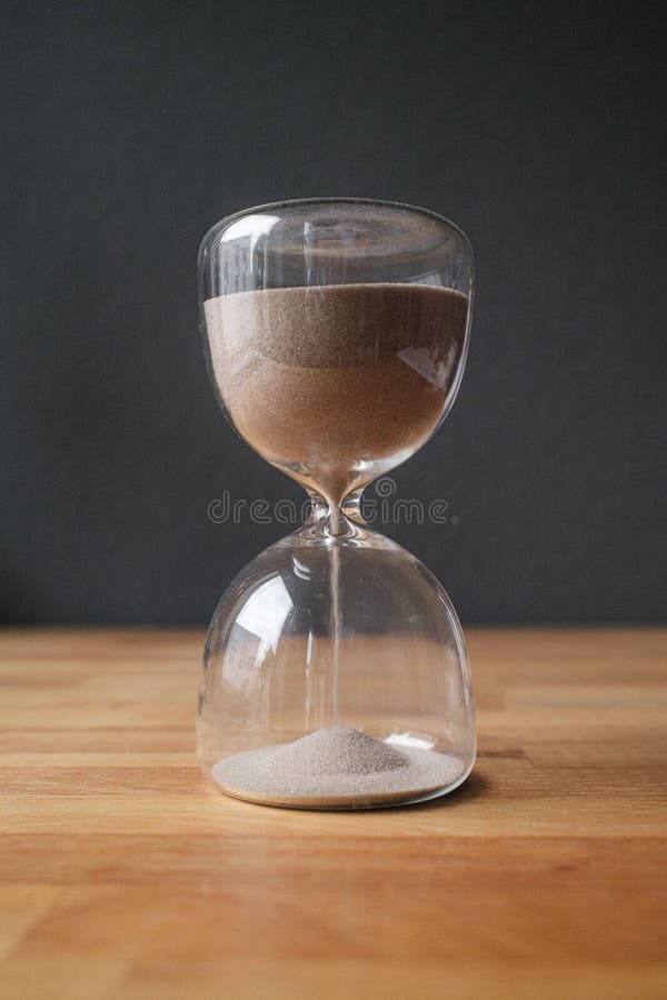 Vertical Closeup of a Small, Simple Hourglass with the Brown Sand ...