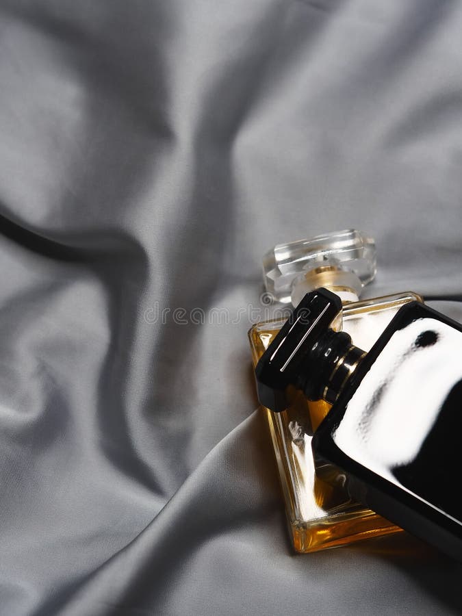 Vertical Closeup Top View of Two Perfume Bottles on a Grey Silk Cloth ...