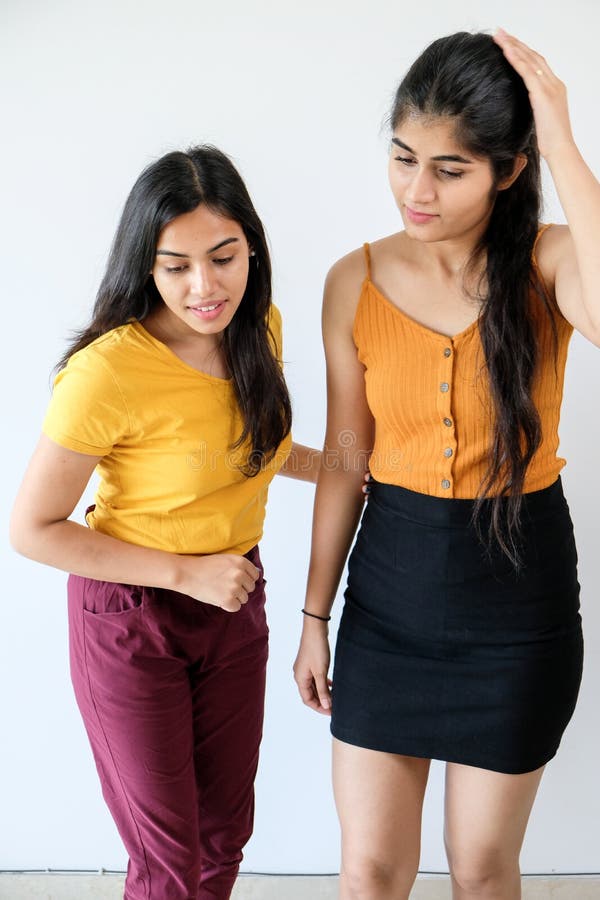 Vertical Closeup of Two Girls Looking Down. Stock Image - Image of pretty, indoors: 262370295