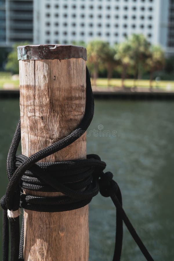 Vertical Closeup of a Wooden Post Wrapped with a Rope on a Pier Stock ...