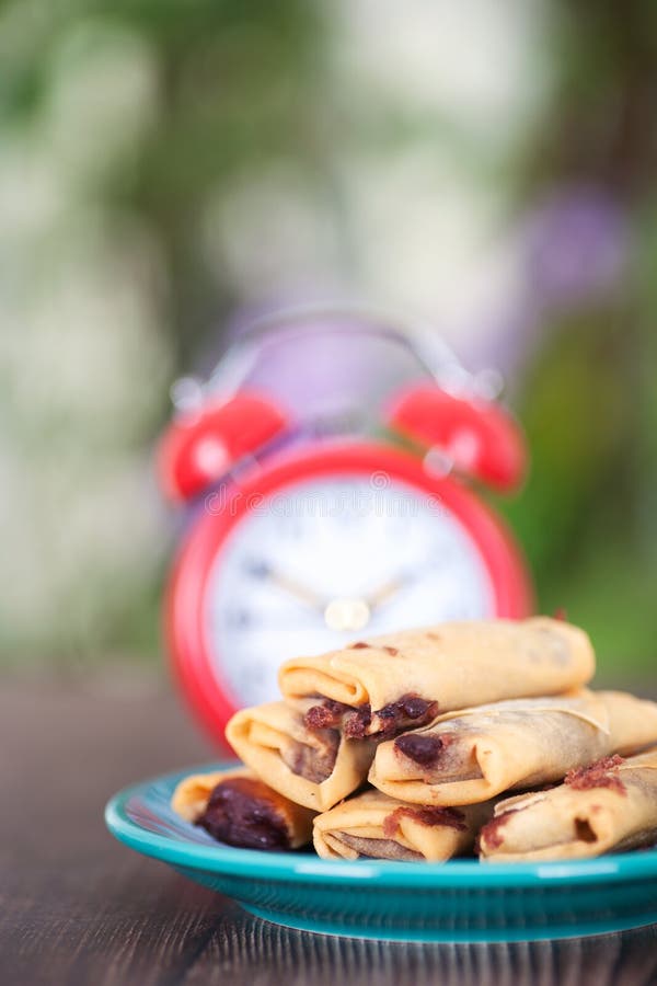 Vertical Composition: a Plate of Fried Spring Rolls and an Alarm Clock ... Vertical Composition: a Plate of Fried Spring Rolls and an Alarm Clock ...
