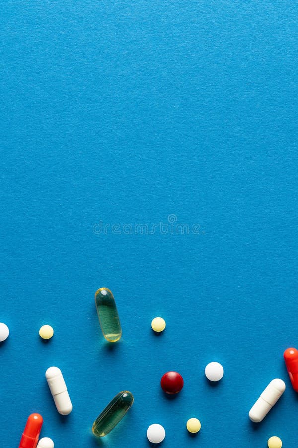 Vertical Composition of a Variety of Pills and Capsules on Blue ...
