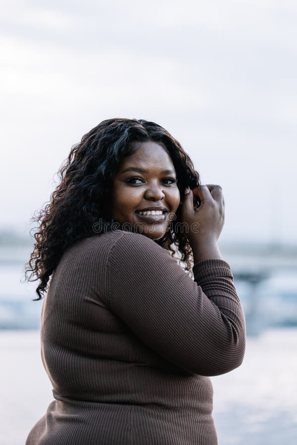 Vertical Confident Black Haired Afro American Plump Woman Look Camera