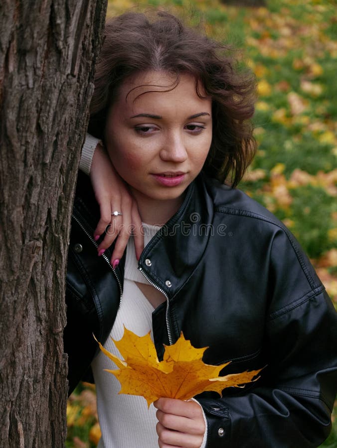 Vertical of a Curly Brunette Caucasian Female Posing with a Yellow ...