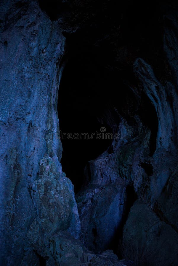 Vertical of a Dark Cave Illuminated by a Single Ray of Light Stock ...