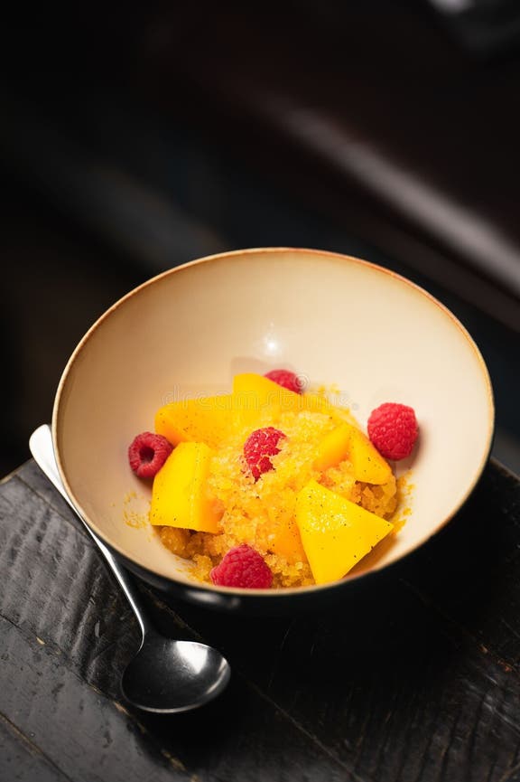 Vertical of a Dessert with Mango and Raspberries Stock Image - Image of ...