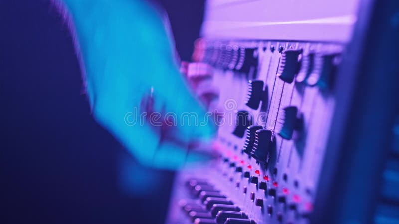 Vertical Hand Adjusts Volume Level Controls on Mixing Console Faders in ...