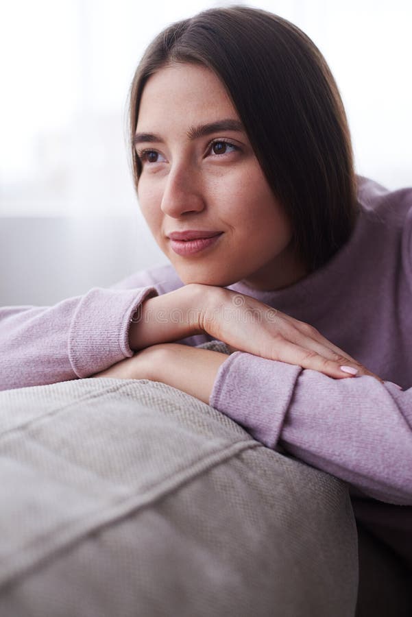 Dreamy Young Girl in Sweater Looking Side, Sitting on Sofa Stock Image ...