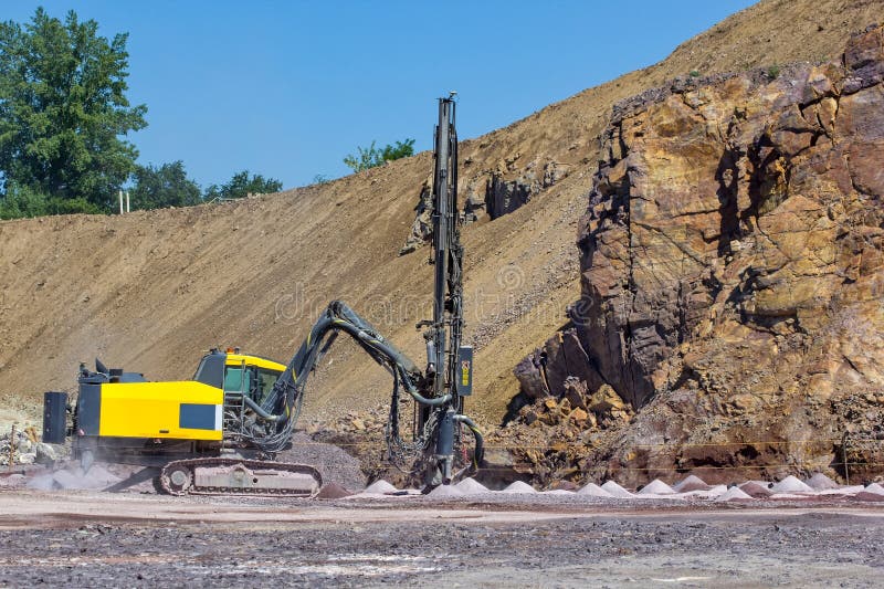 The Vertical Drilling Rig Machine in Stone Quarry. Stock Photo - Image ...