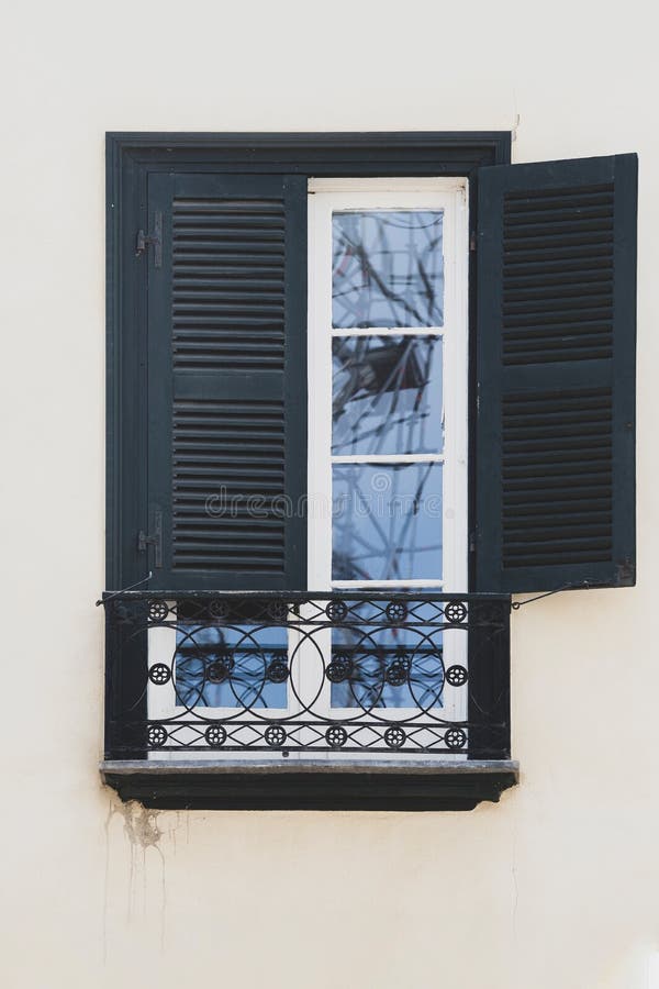 Vertical Eye-level Shot of the Facade of a White Building with a Window ...