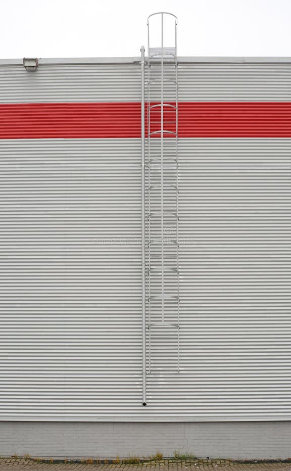 Vertical Fire Escape on a Gray Metal Wall Stock Photo - Image of ...