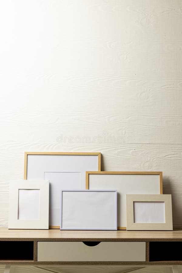 Vertical of Five Various Empty Frames with Copy Space on Table Against ...
